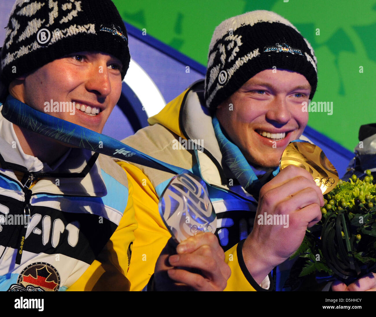 Gold medalist Felix Loch (R) and silver winner David Moeller of Germany ...