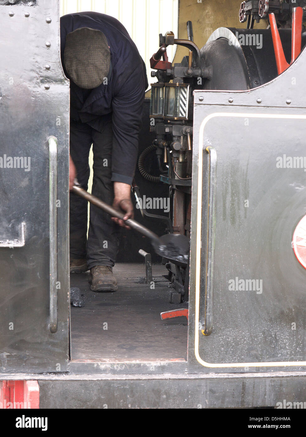 Fireman stoking the boiler on a steam loco,Lincs Wolds Railway easter ...