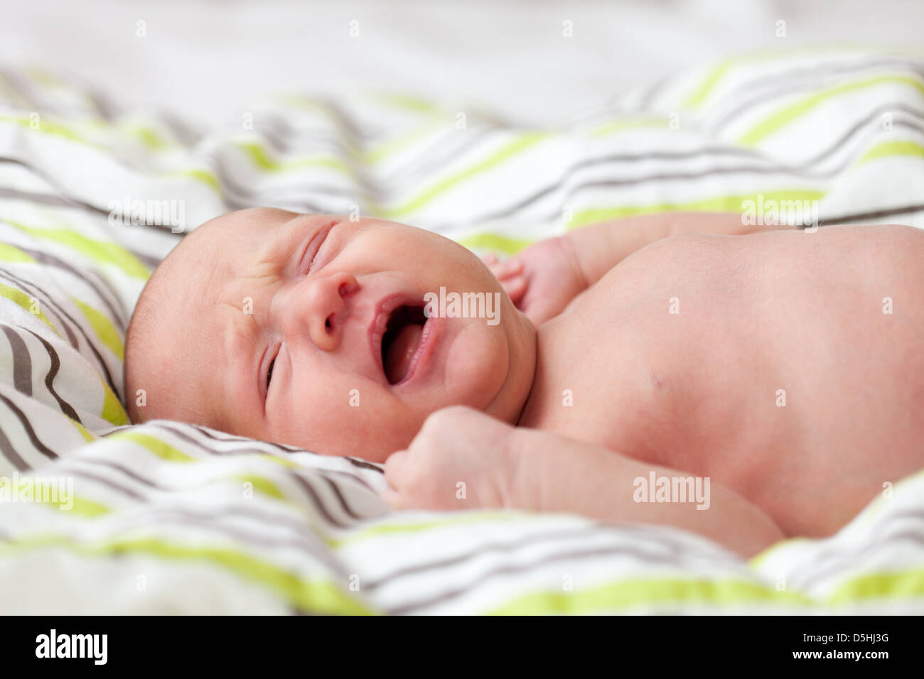 Newborn baby cryingg on the bed, selective focus Stock Photo - Alamy