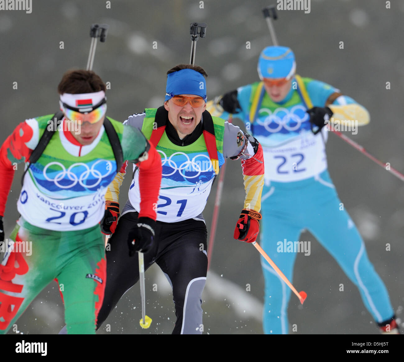 Michael Greis (C) of Germany in action next to Alexandr Syman (L) of ...