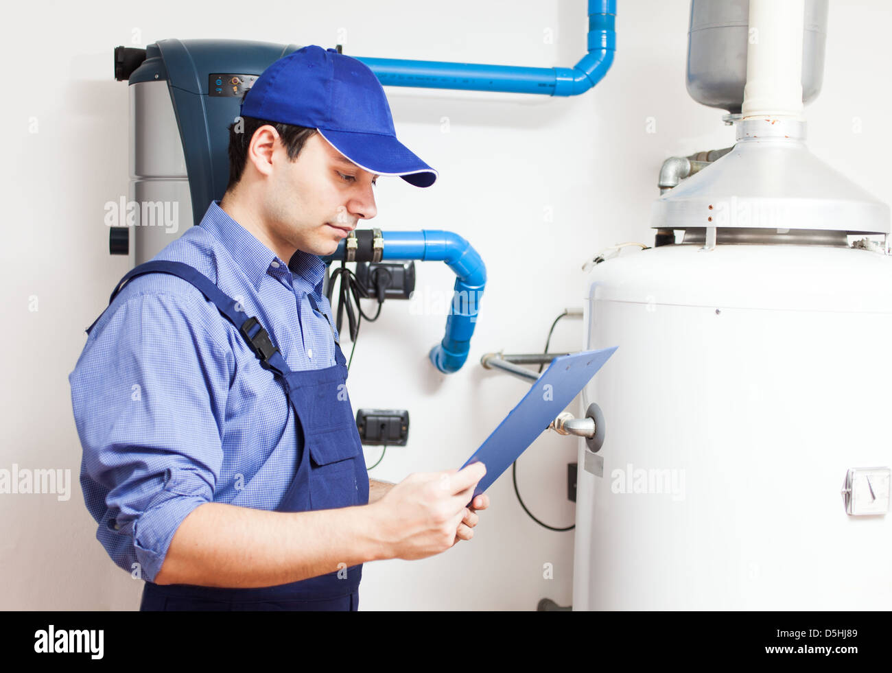 Technician servicing an hot-water heater Stock Photo - Alamy