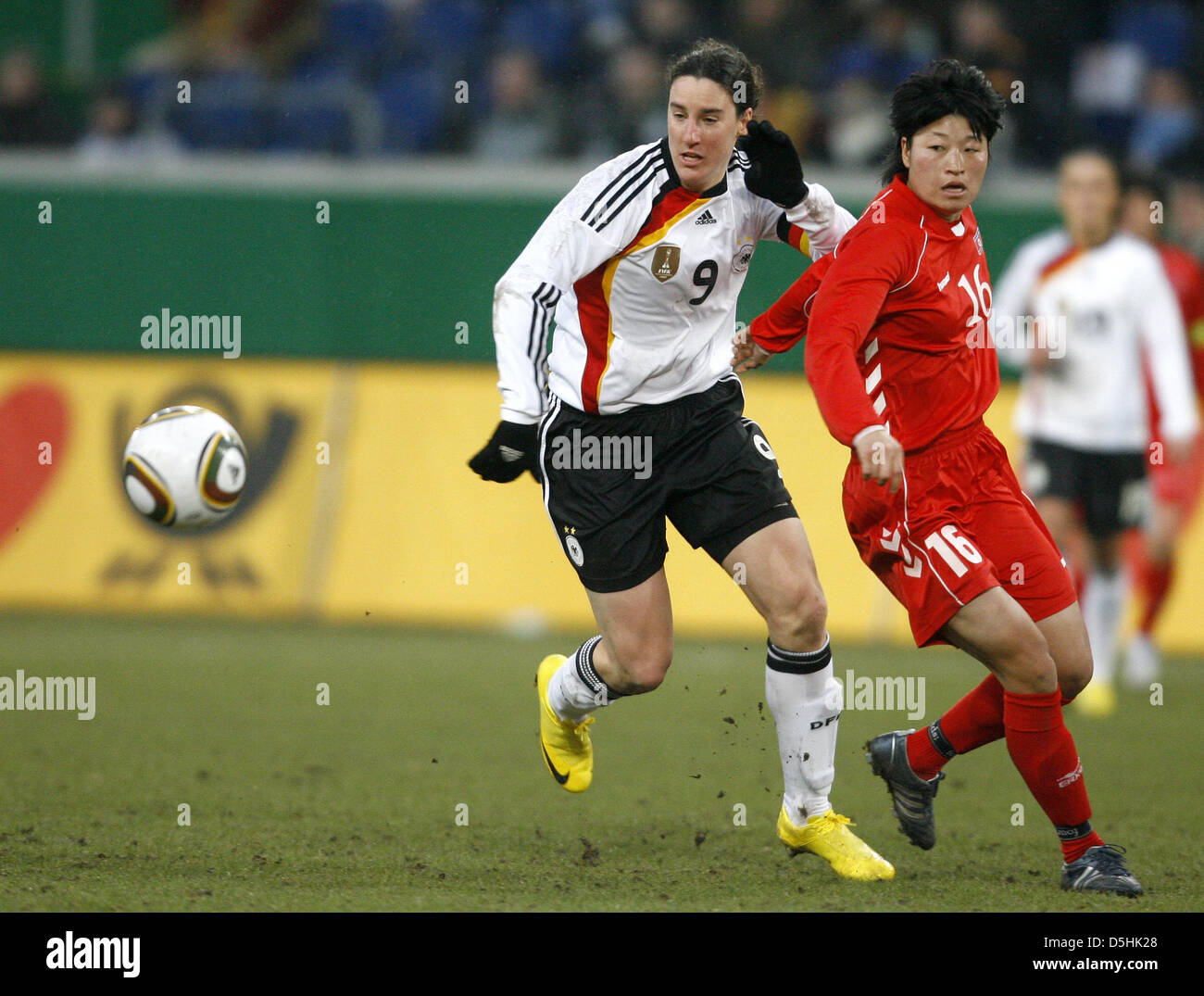 Germany's Birgit Prinz (L) and North Korea's Yu Jong Hu vie for the ...