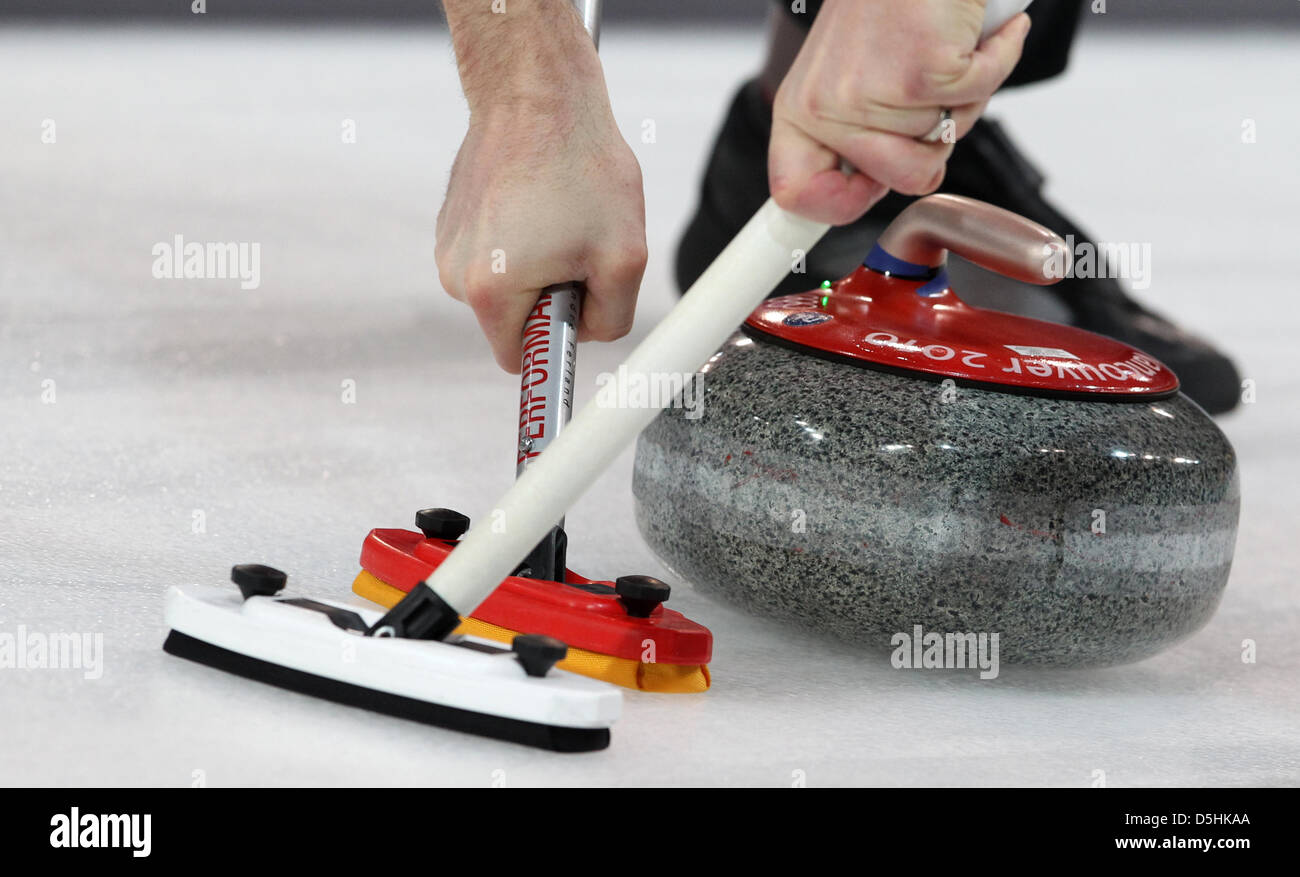 Players of Germany sweep to guide the stone during Curling men's round ...