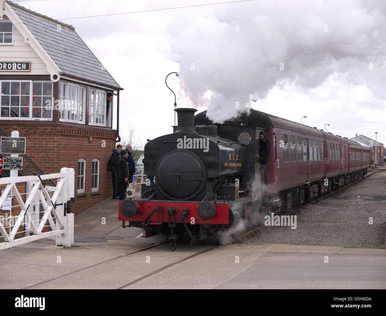 N.C.B. steam loco and BR MK 1 coaches crossing the level crossing at ...