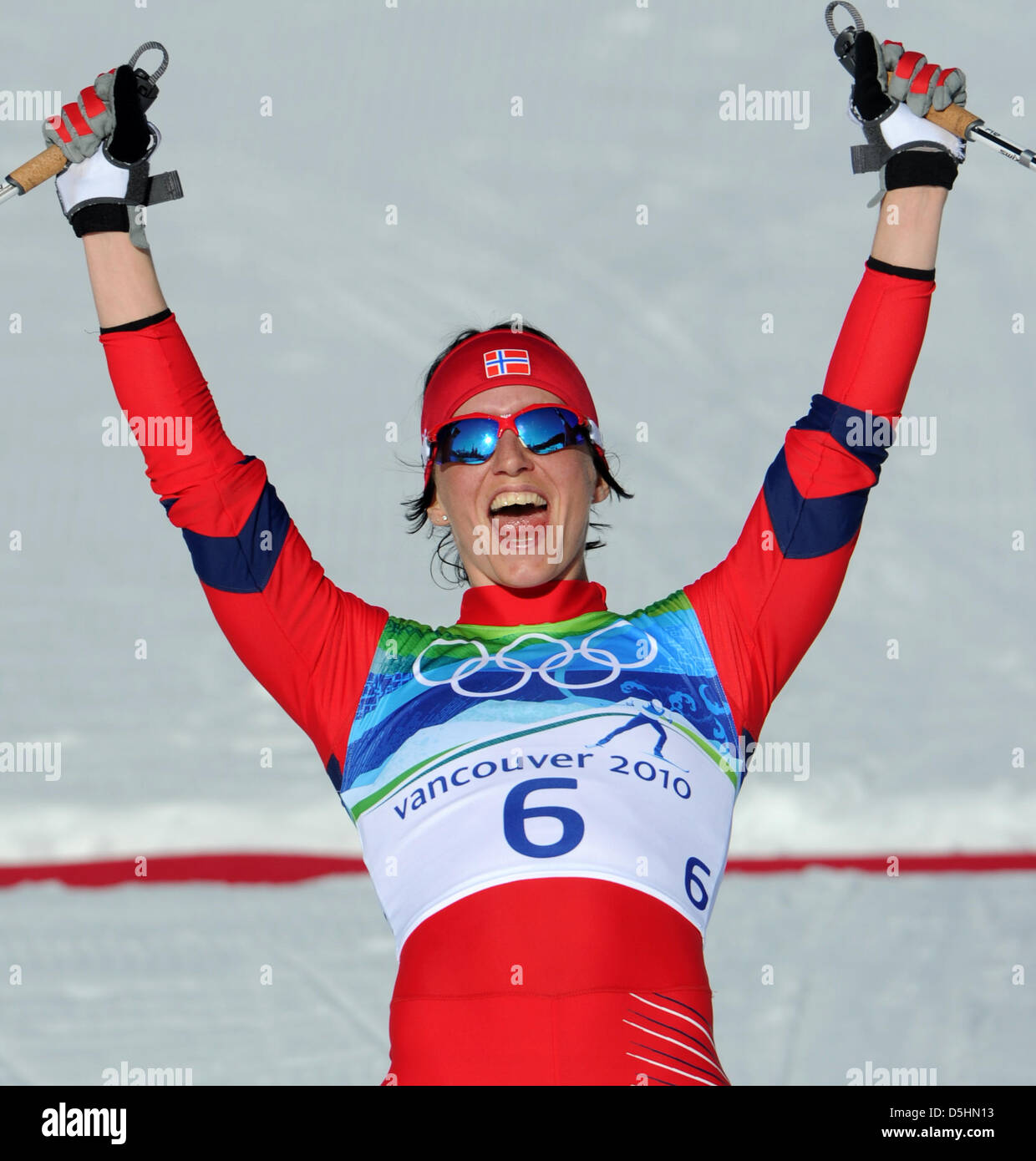 Gold medalist Marit Bjoergen of Norway celebrates after she cross the ...