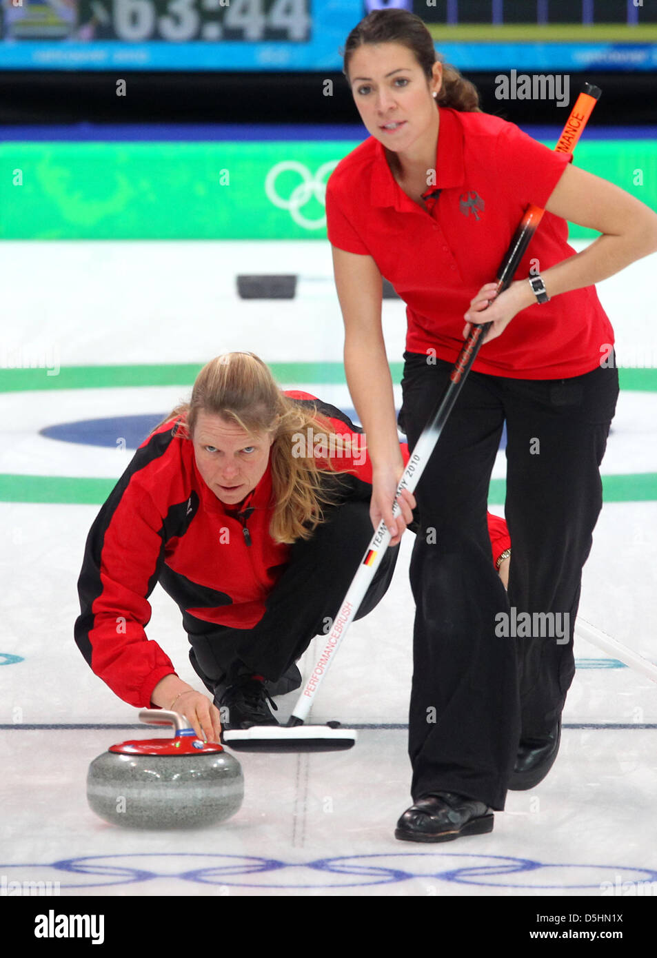 Andrea Schoepp (L) of team Germany pushes the stone while teammate ...