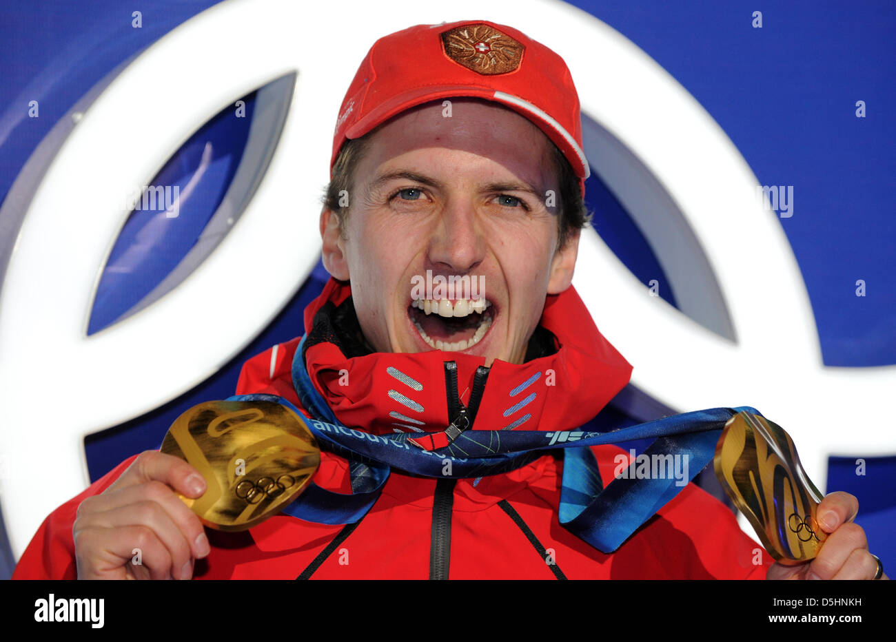 Gold medalist Simon Ammann of Switzerland shows his two gold medals ...
