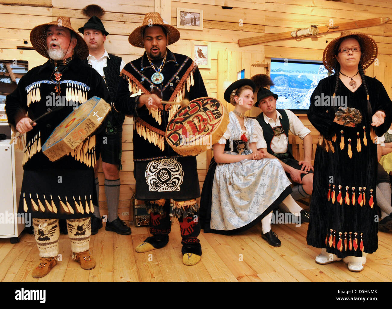A Canadian First Nations Dance Group performs watched by Bavarian folk ...