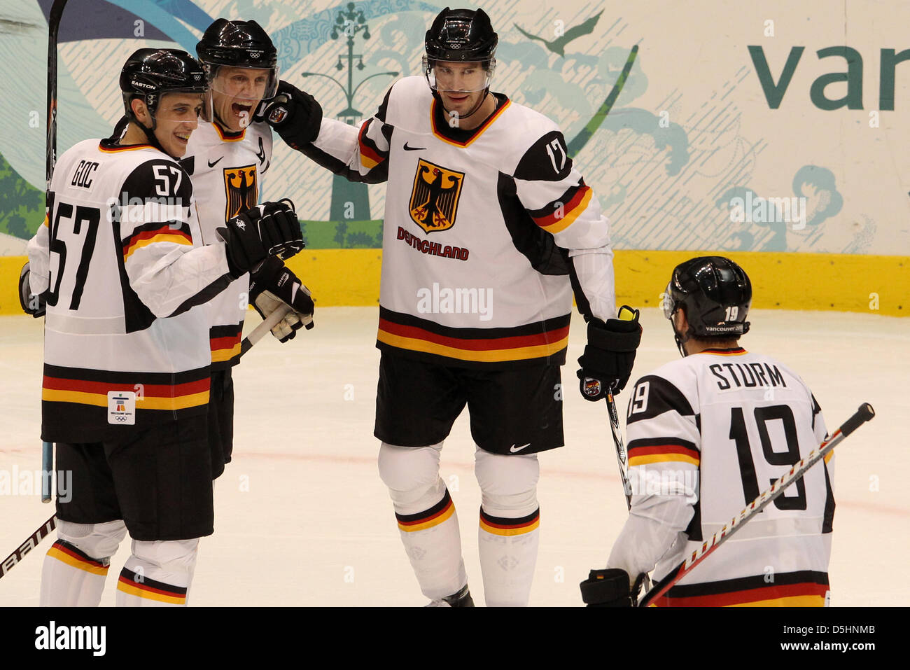 Marco Sturm (R), Marcel Goc (L), Dennis Seidenberg (C) and Jochen Hecht of Germany cheer during ...