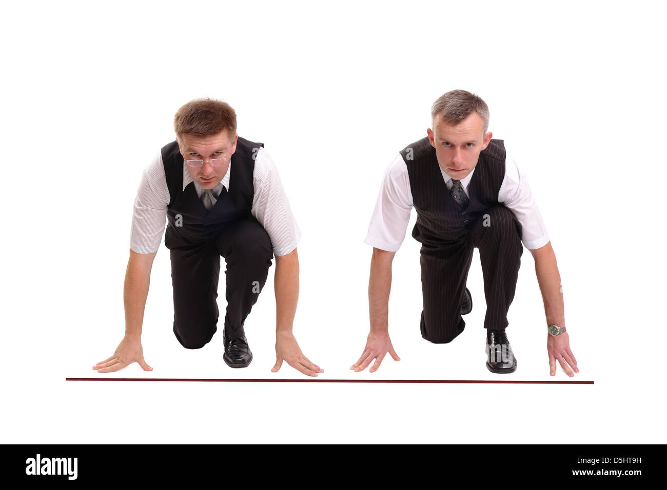 Two businessmen lined up on starting line getting ready for corporate ...