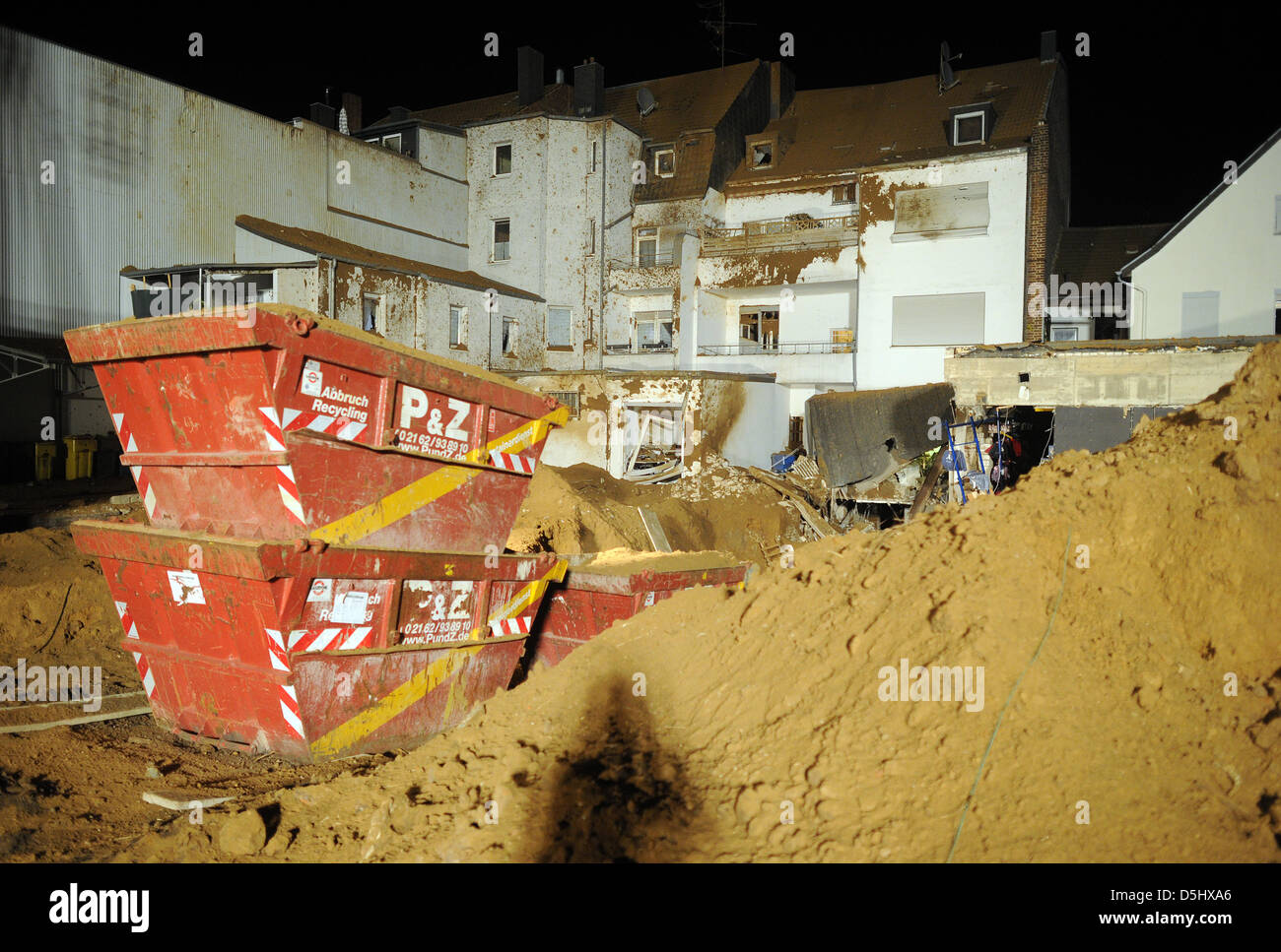 A huge carter is illuminated after the controlled blast of a WWII bomb ...