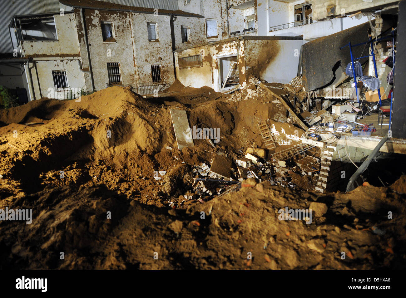 A huge carter is illuminated after the controlled blast of a WWII bomb ...