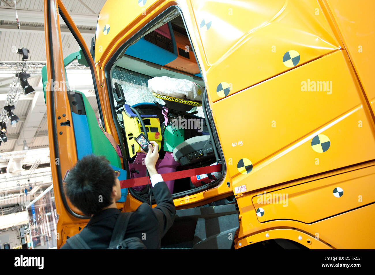 A visitor photographs the cockpit of a Volvo truck at the International ...