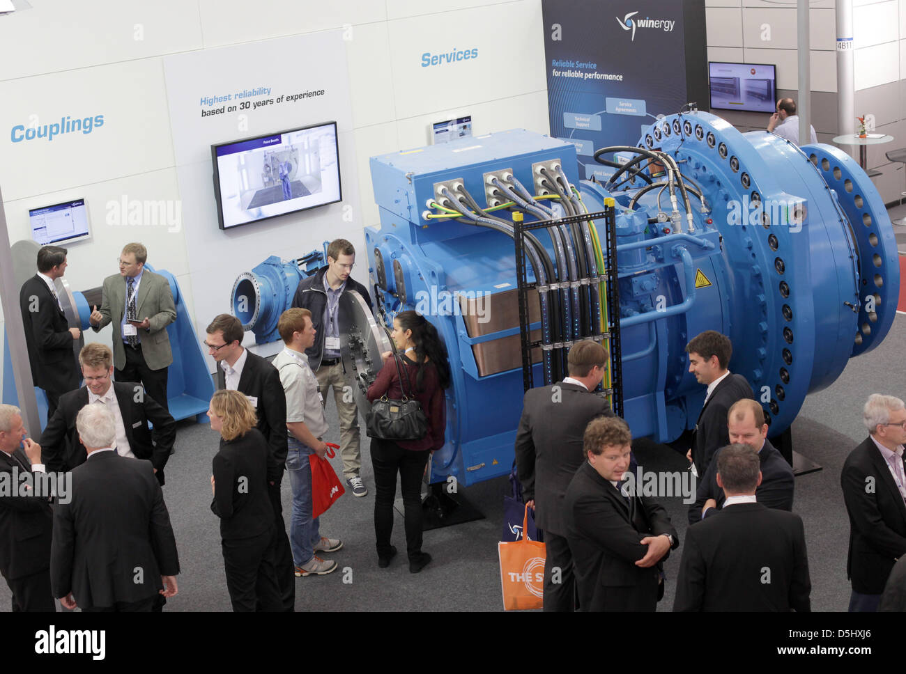 Visitors look at a Winergy HybridDrive, motor and generator in one unit ...