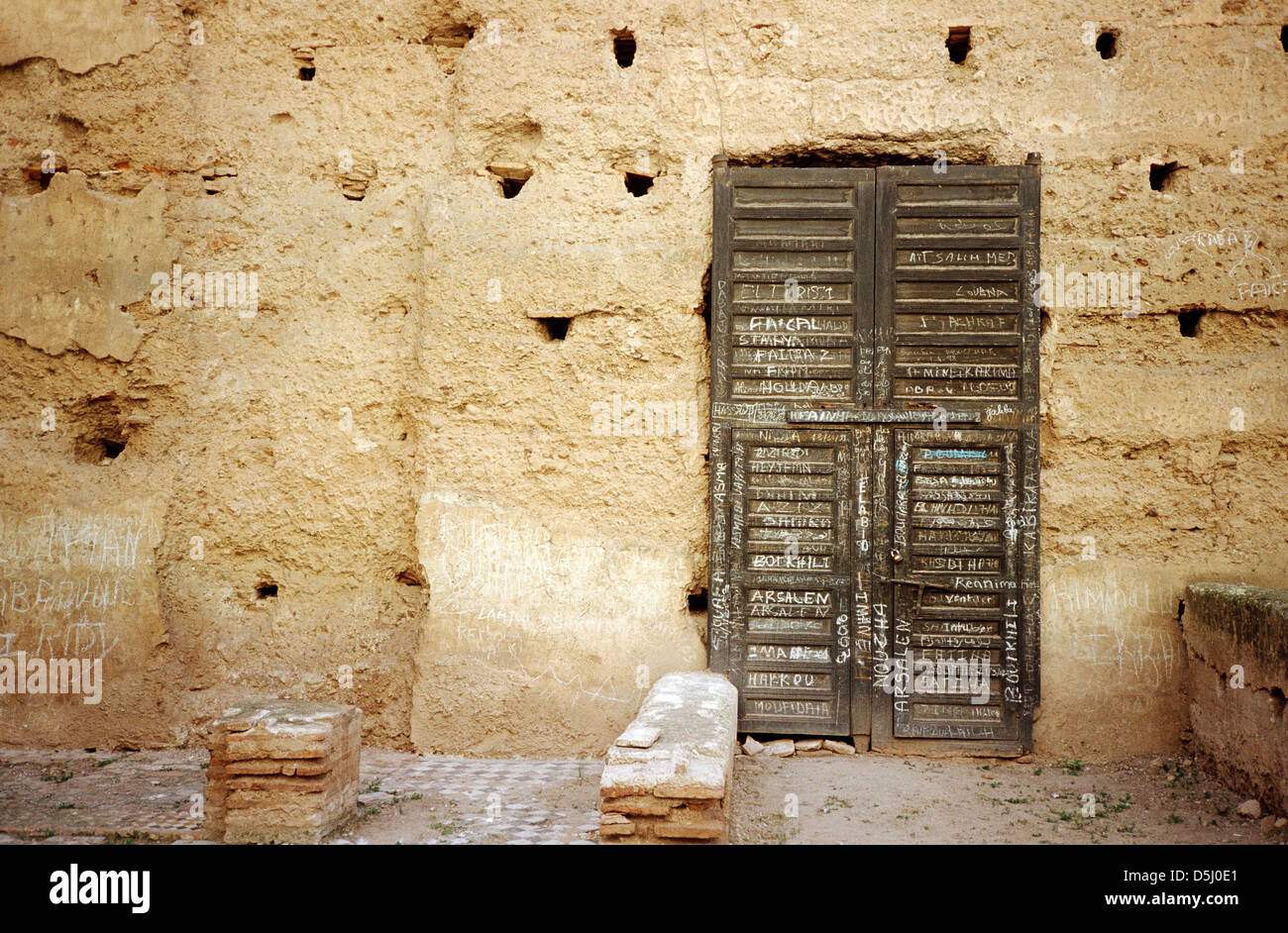 Ancient wooden door and graffiti, El Badi palace, Marrakesh, Morocco ...