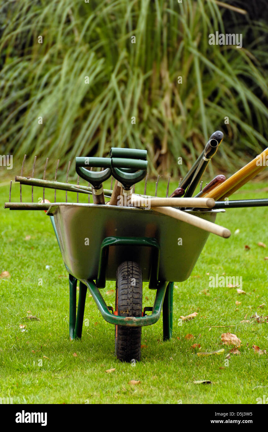 Garden wheelbarrow with tools Stock Photo - Alamy