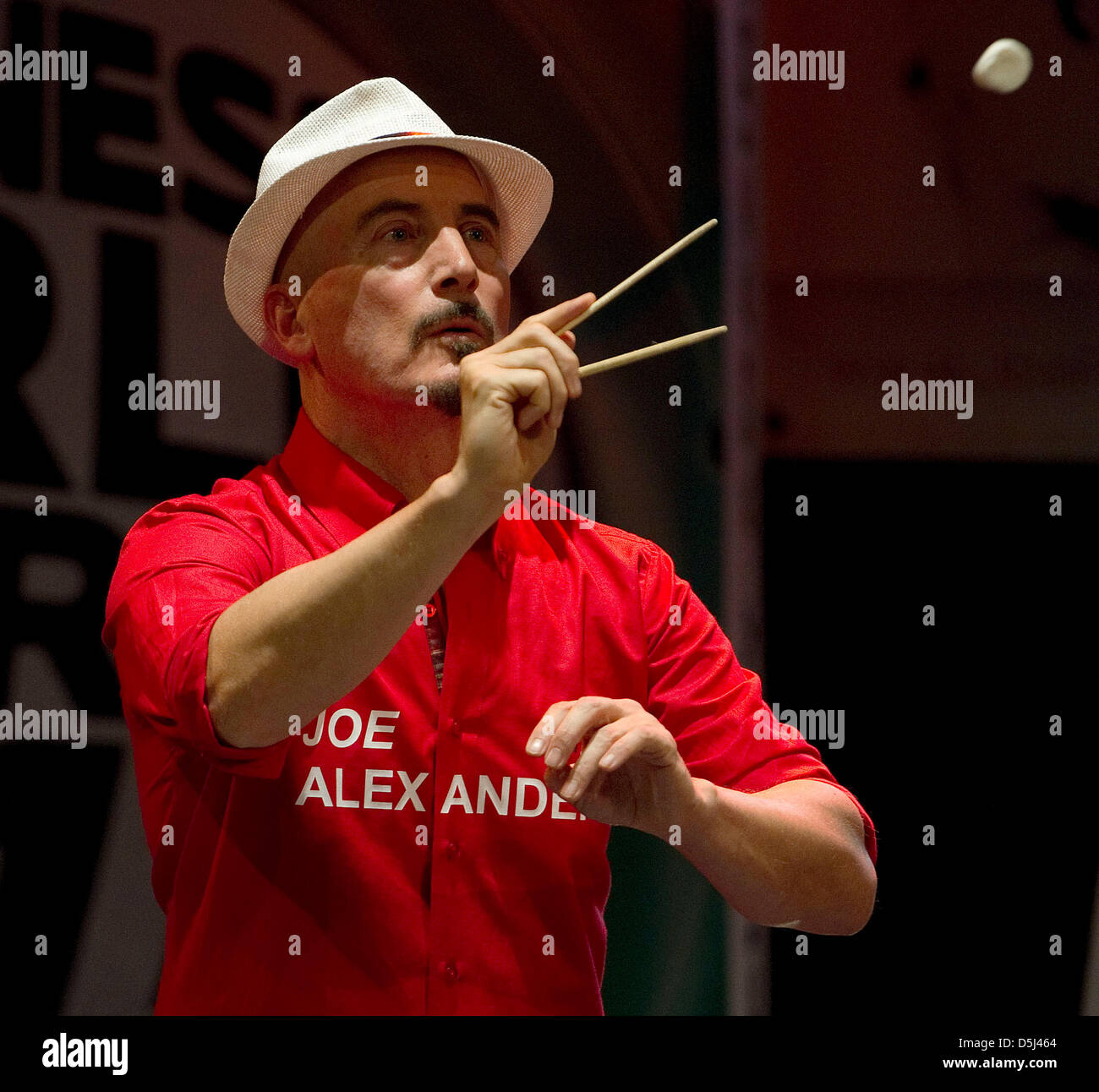 Entertainer Joe Alexander catches a marshmallow with a pair of ...