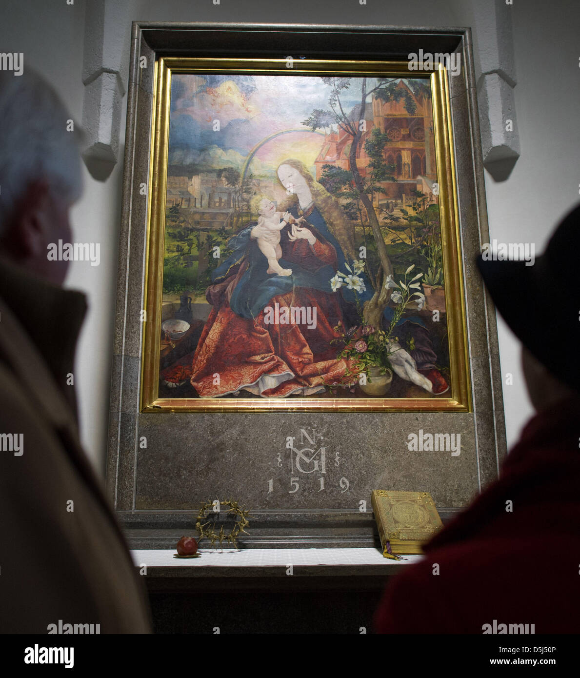 Two visitors observe the retored painting 'Stuppach Madonna' by ...