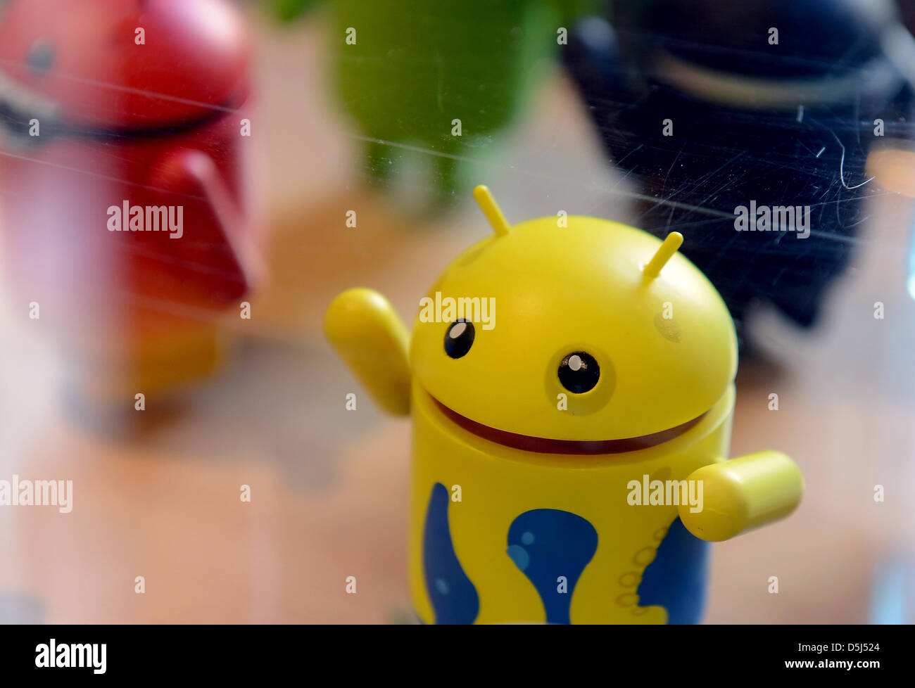 Colorful mini Android toys are pictured in a glass cabinet at the ...
