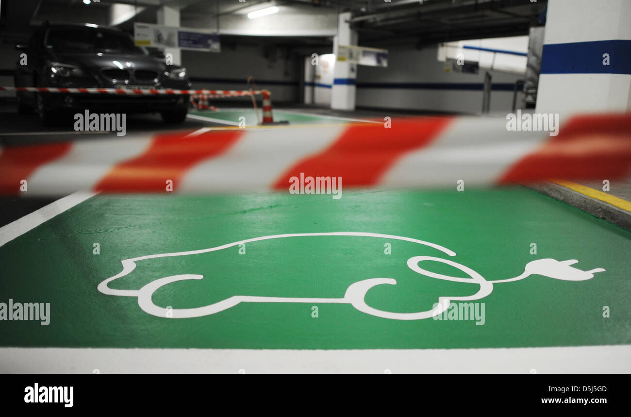 A tape blocks of a freshly painted parking place for electric cars in a ...