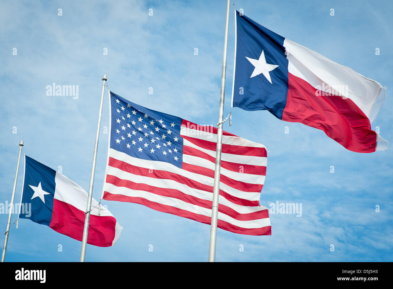 A US-American national flag (C) and two Texas state flags waving in ...
