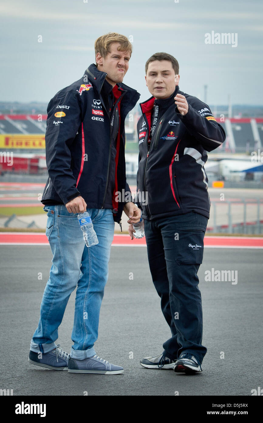 German Formula One driver Sebastian Vettel (L) of Red Bull walks with ...