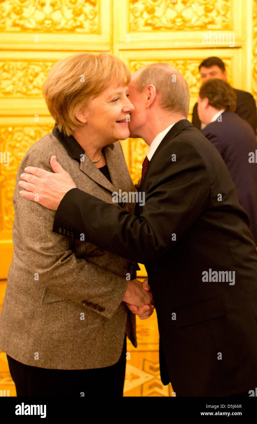 German Chancellor Angela Merkel greets the President of Russia Vladimir ...
