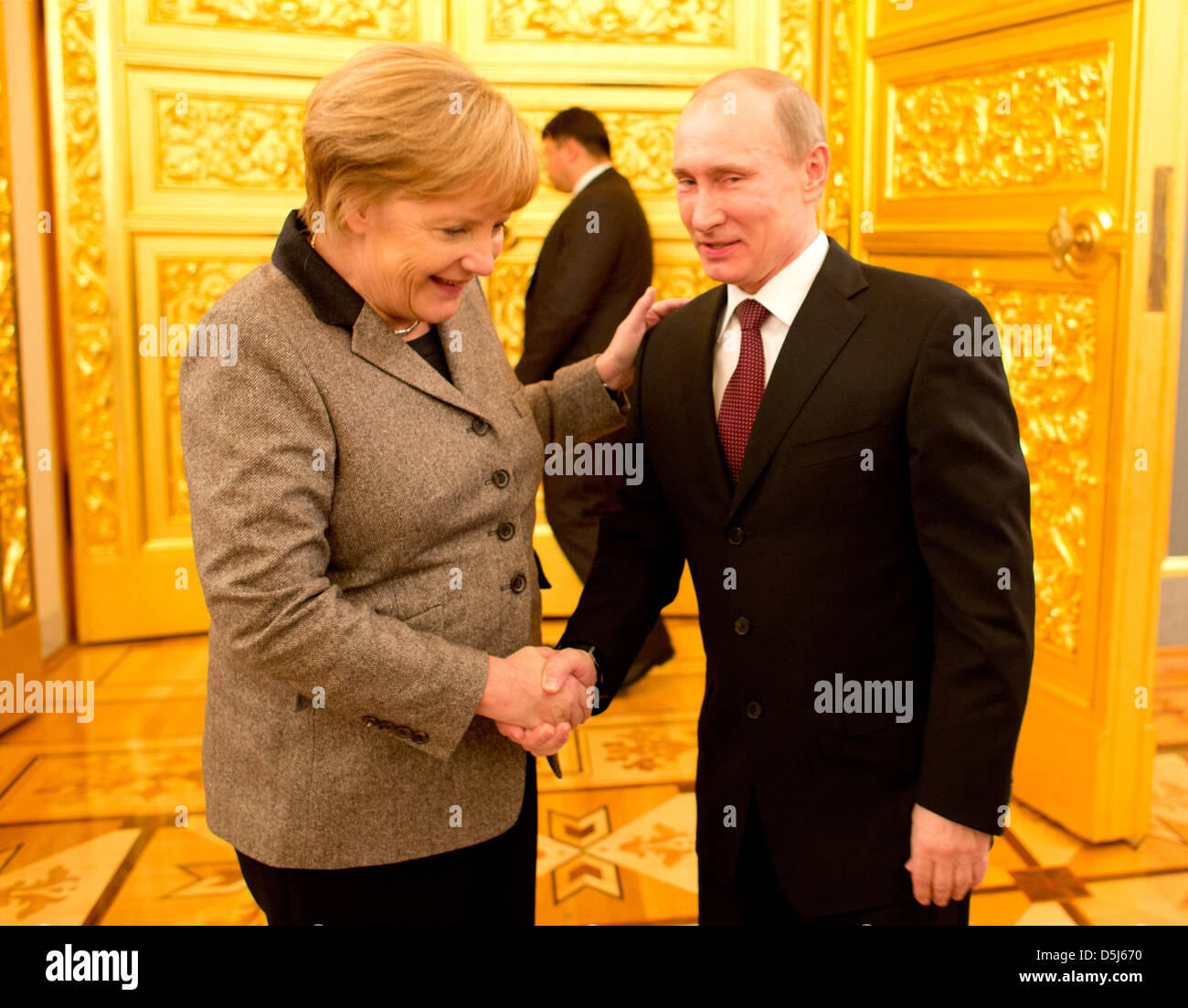 German Chancellor Angela Merkel greets the President of Russia Vladimir ...