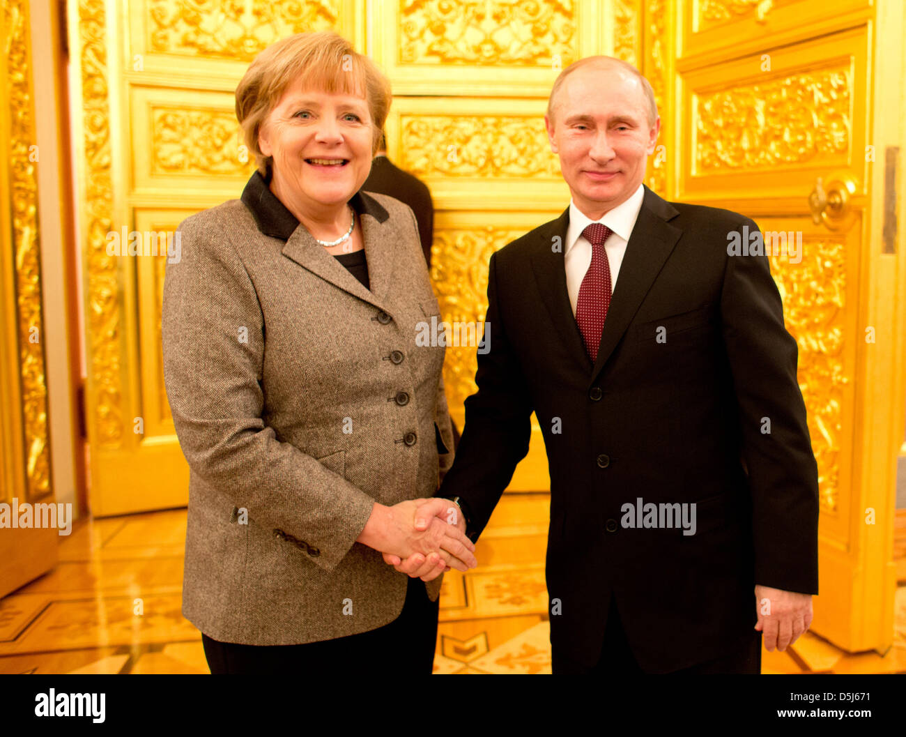 German Chancellor Angela Merkel greets the President of Russia Vladimir ...