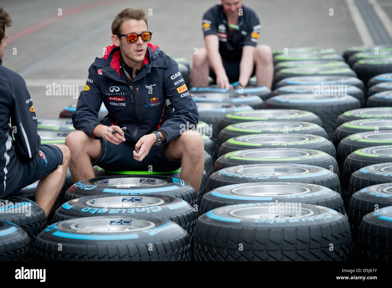 Red Bull mechanics prepare Pirelli tyres in the paddock at the Circuit ...