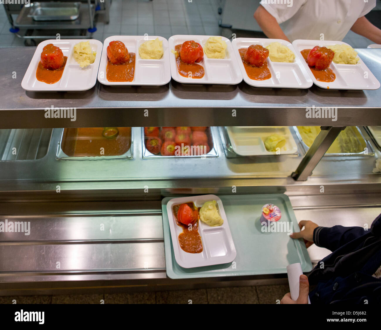 Asylum seekers queue at the food counter in the central registration ...