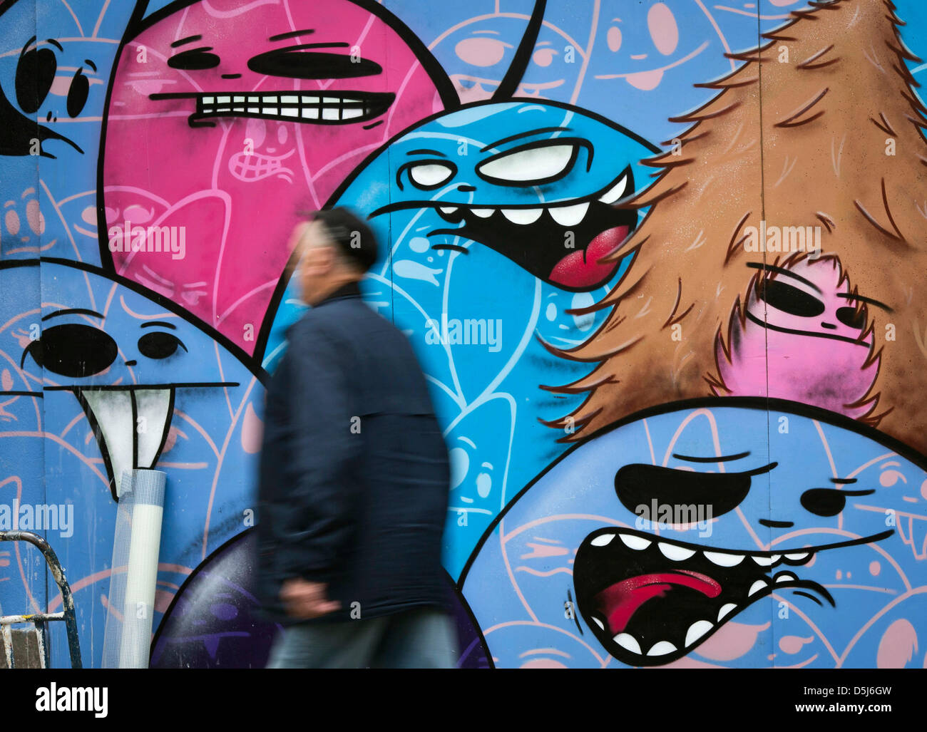 A man walks past a spooky graffiti in Frankfurt Main, Germany, 16 ...