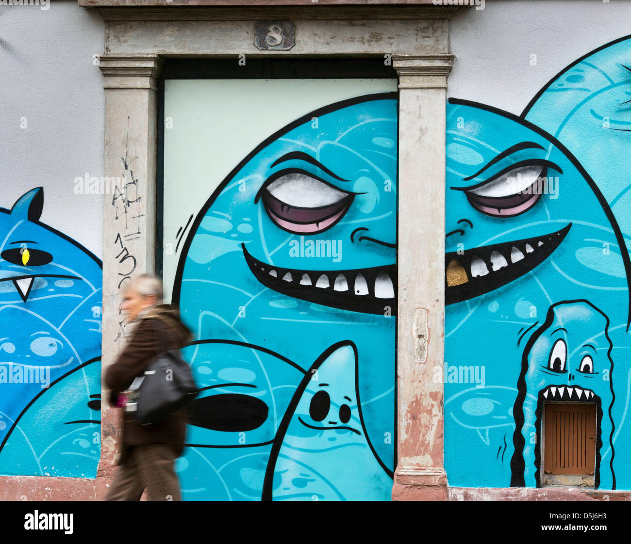 A woman walks past a spooky graffiti in Frankfurt Main, Germany, 16 ...