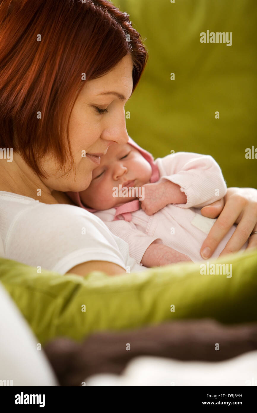 Mother holding newborn baby girl Stock Photo - Alamy