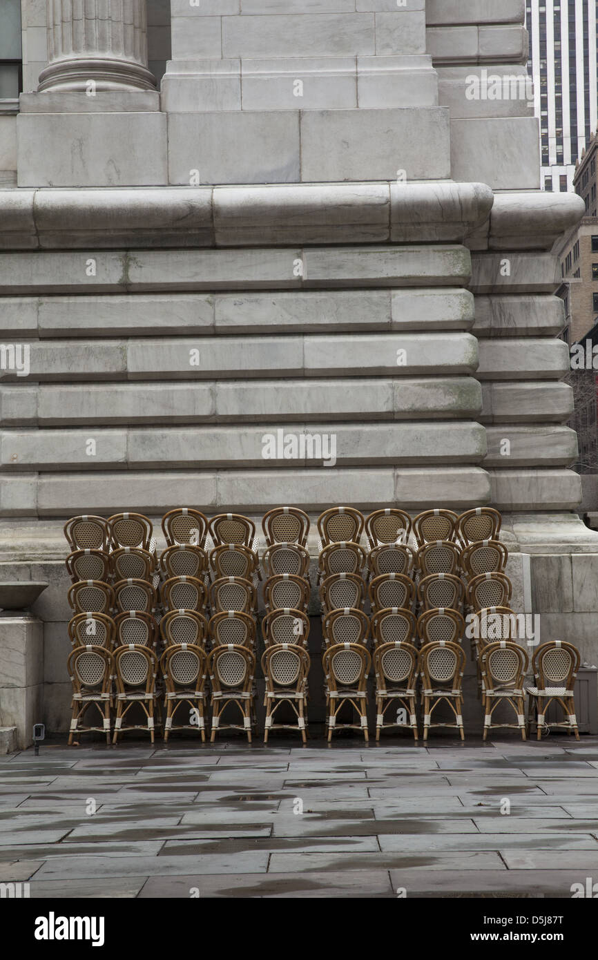 Stacked cafe chairs at Bryant Park behind the New York Public Library ...