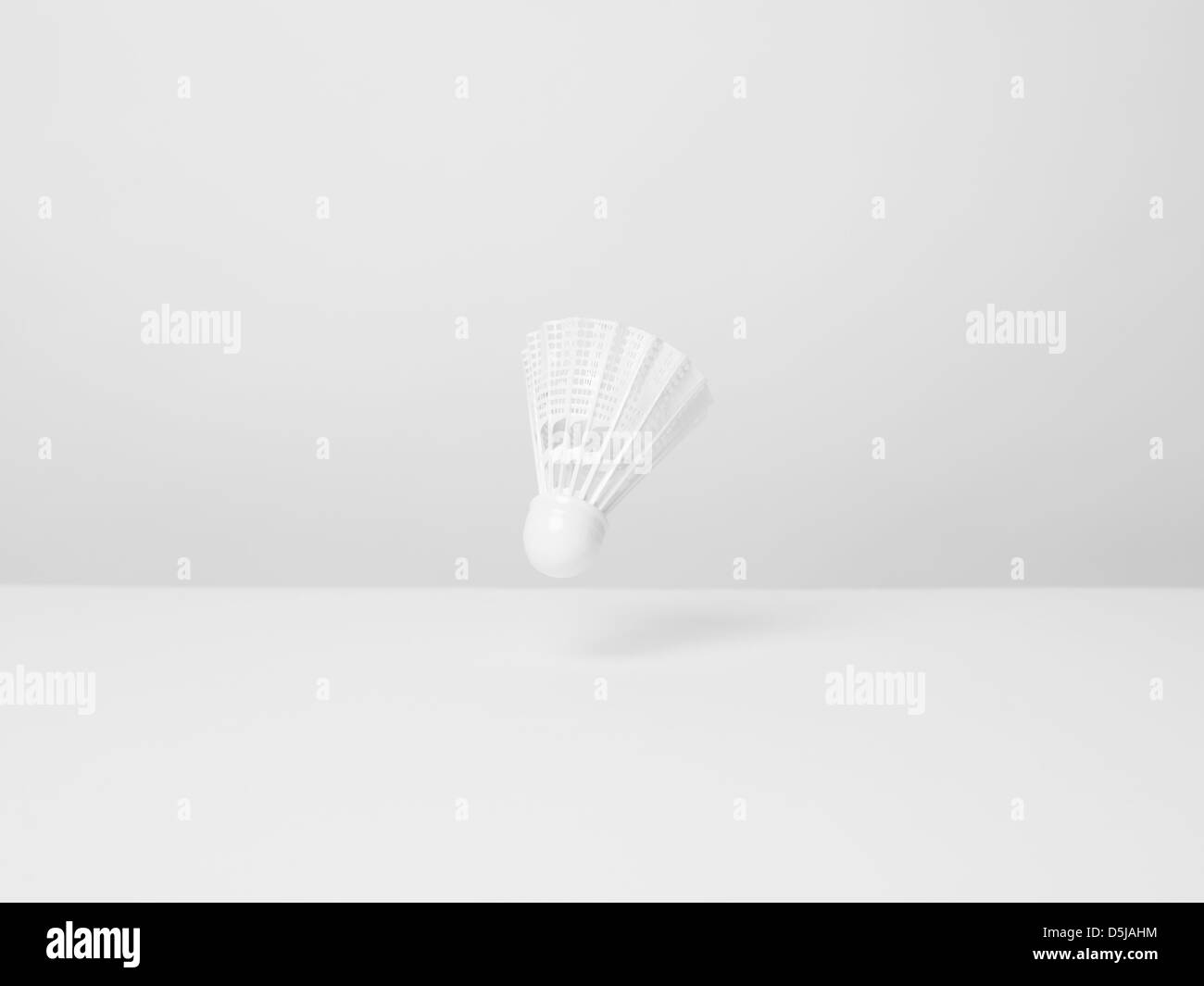A shuttle cock floating above a white surface Stock Photo - Alamy