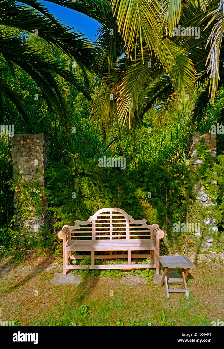 A seat under the palm trees in a Provencal garden, in the south of ...