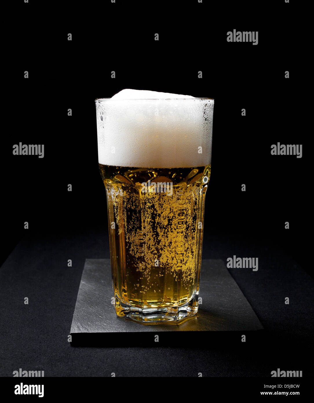 Pint with a head Stock Photo - Alamy