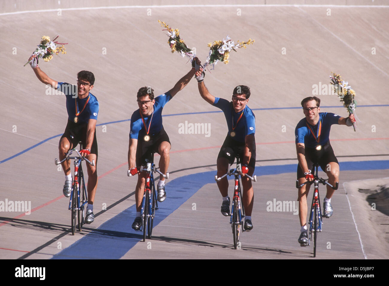 Victorious male cycling team on the velodrome Stock Photo - Alamy