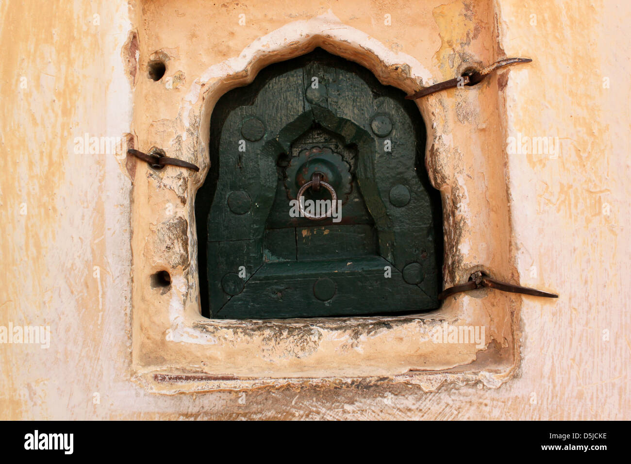 Small opening in wall with woodden door Stock Photo - Alamy