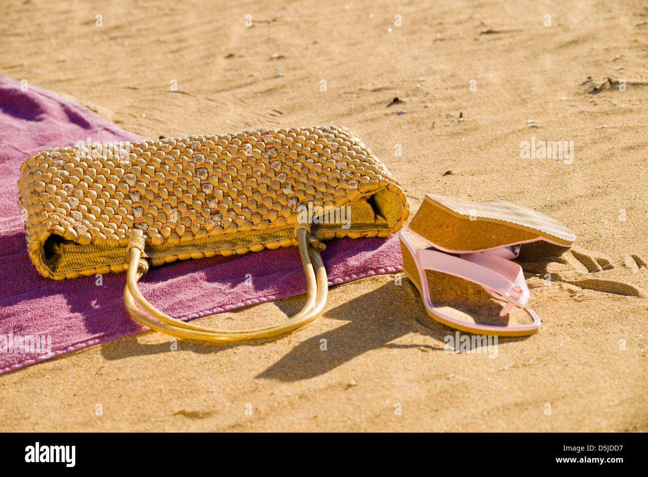 Beach items resting on sunny beach sand Stock Photo - Alamy