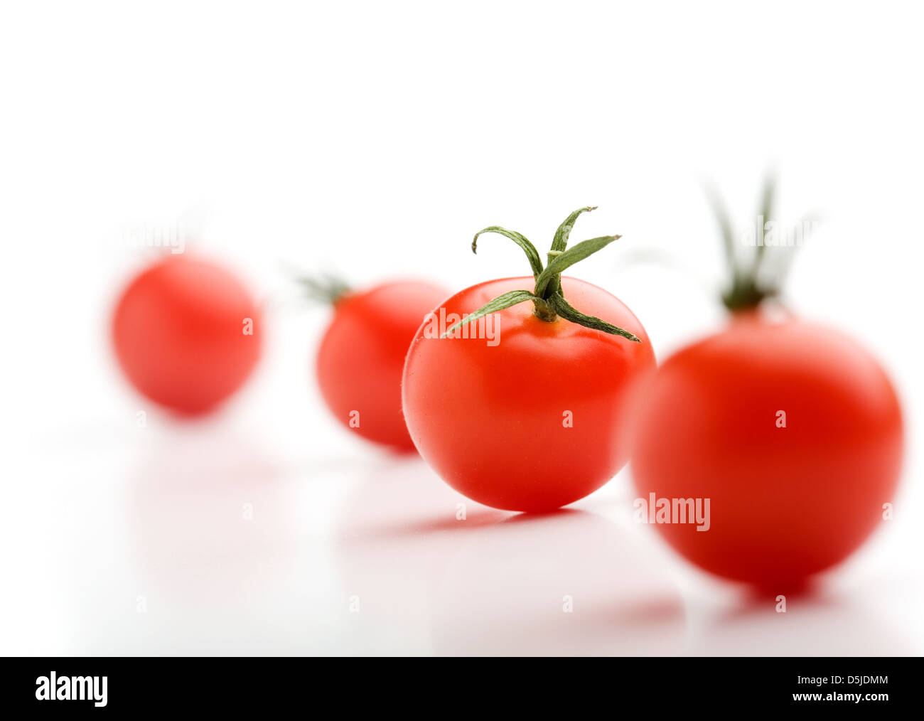 Mini cherry tomatoes isolated on white background Stock Photo - Alamy