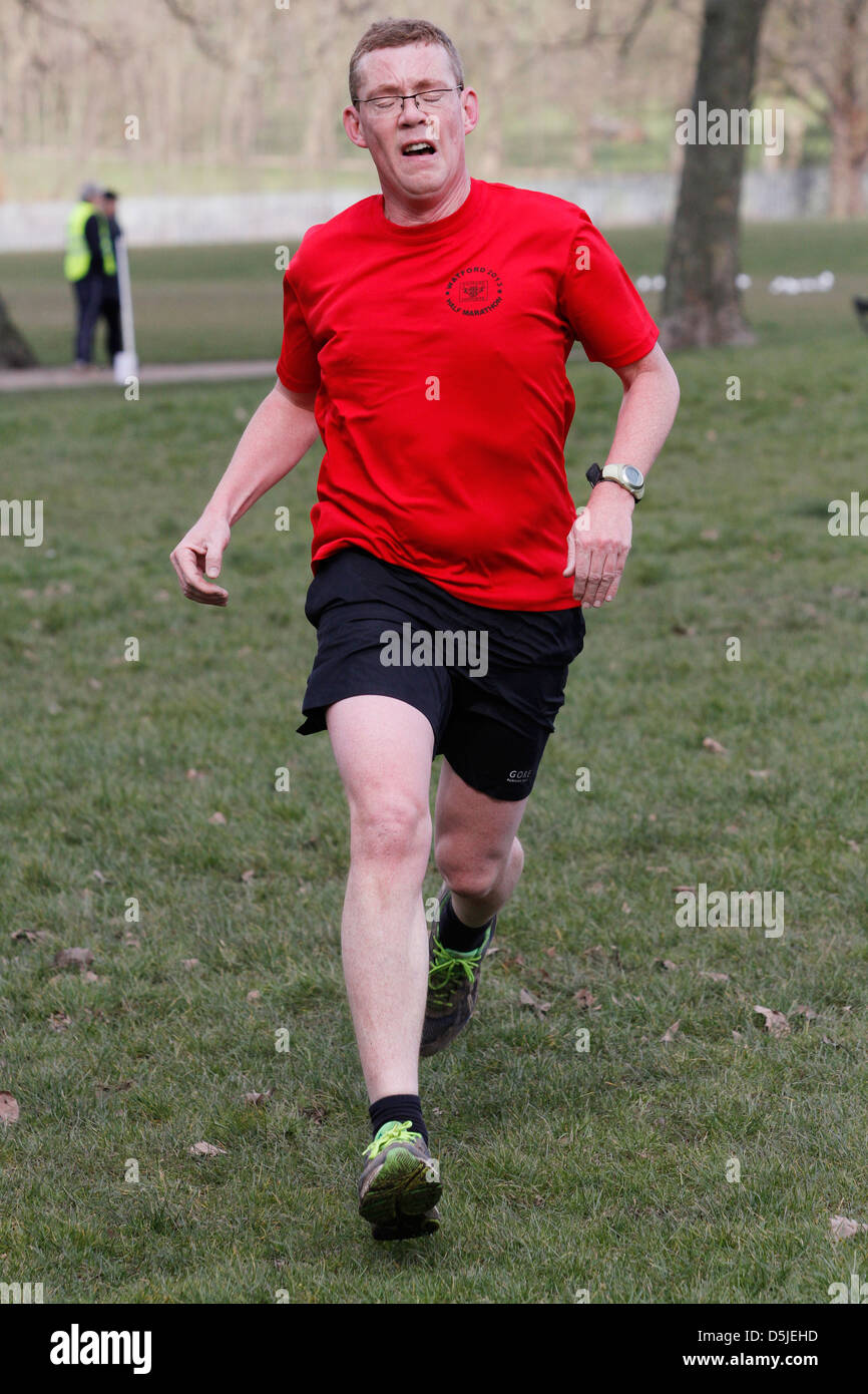 Man running in the park heading towards finishing line at a race, known ...