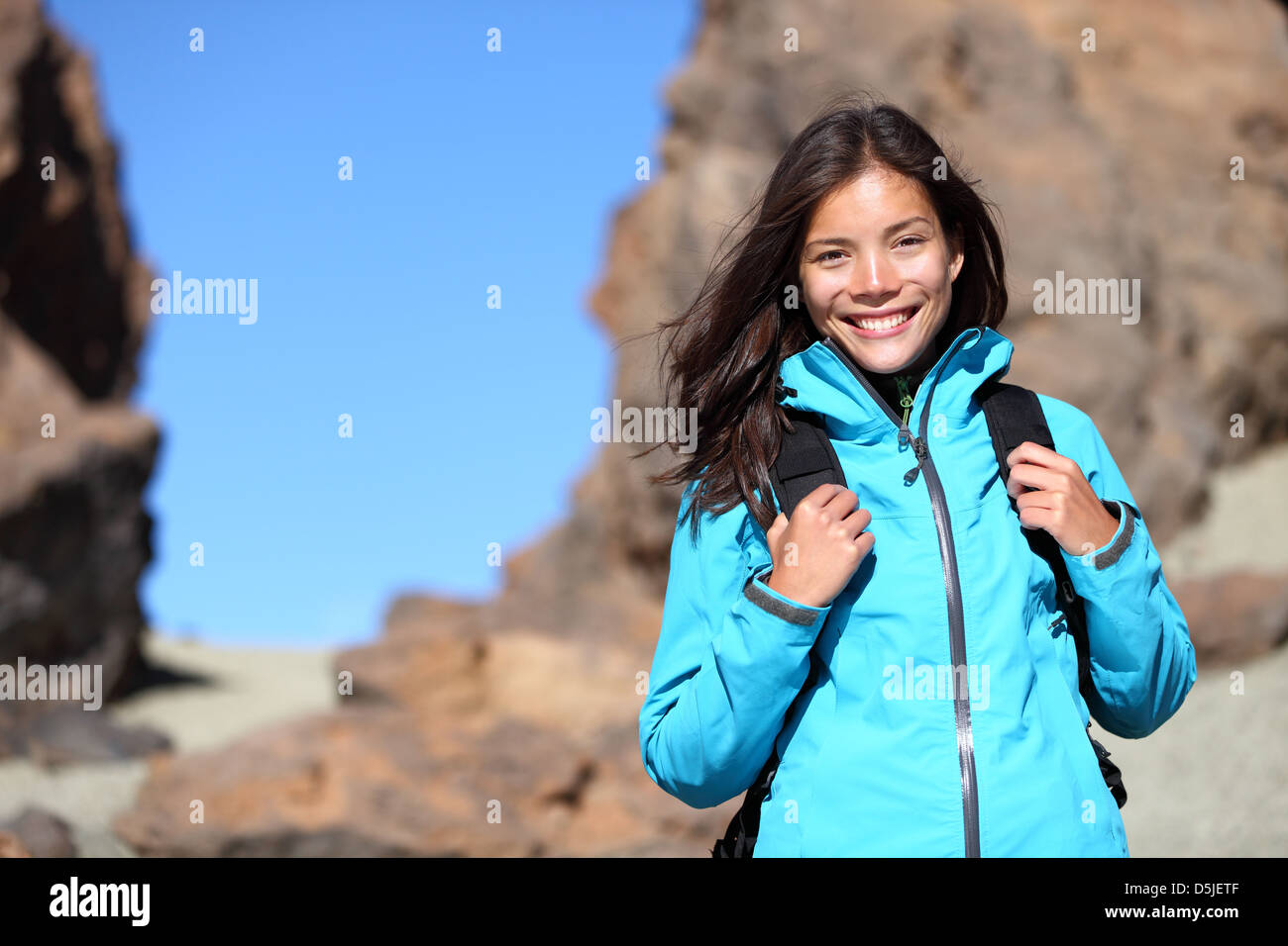Portrait of happy multicultural young woman with backpack walking in ...