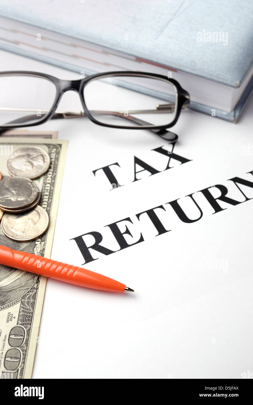 Tax return papers with glasses, pen and money Stock Photo - Alamy