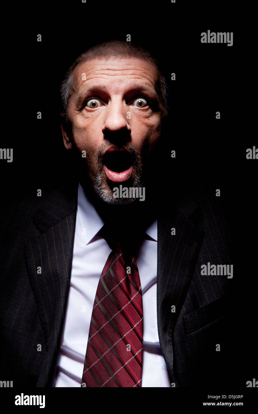 Scared man in business suit Stock Photo - Alamy