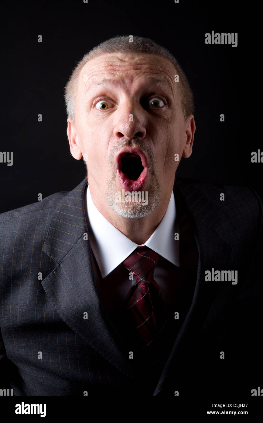 Businessman screaming at camera Stock Photo - Alamy