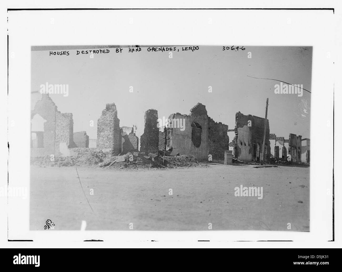 This image depicts houses in Lerdo, Mexico, destroyed by hand grenades ...