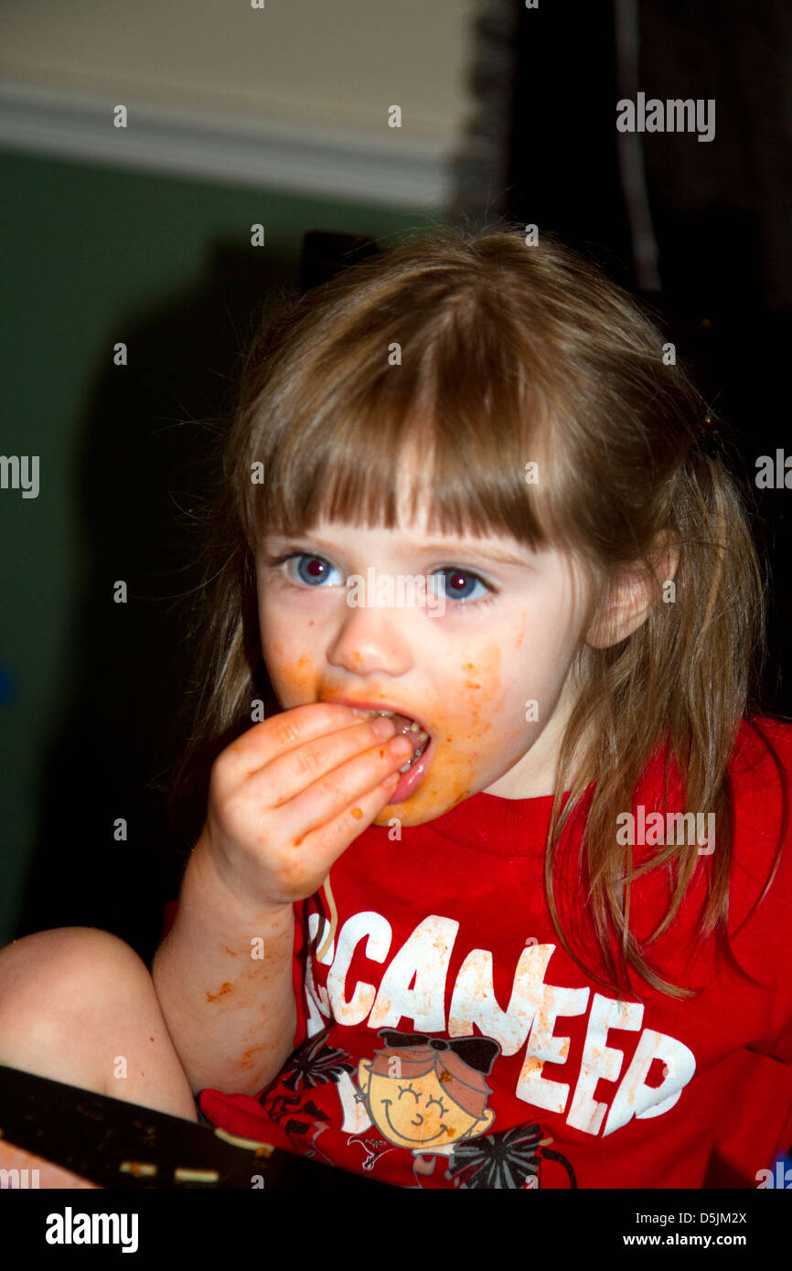 Two year old girl eating spaghetti and getting it all over her face ...