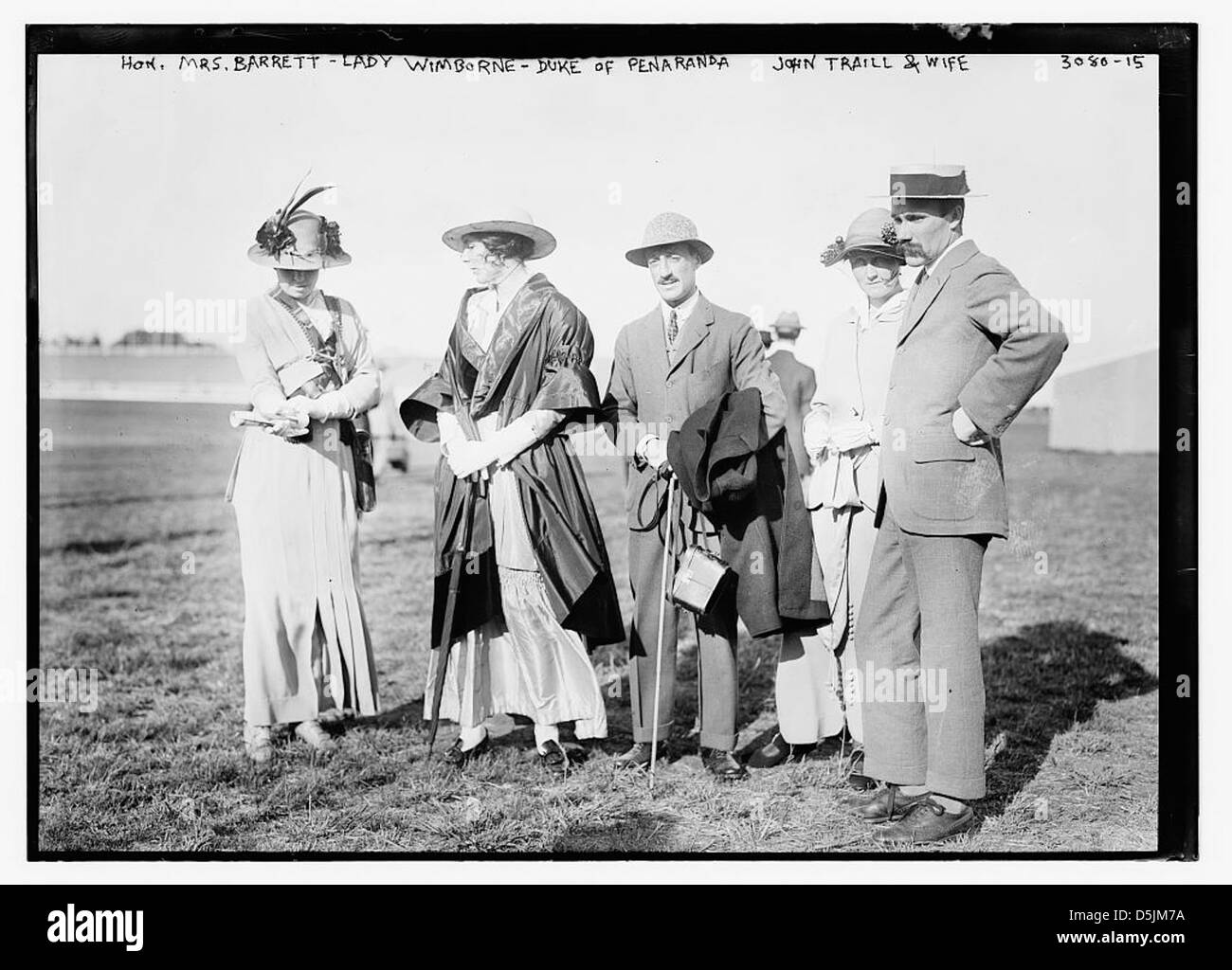 The image shows a group of distinguished individuals, including Hon ...